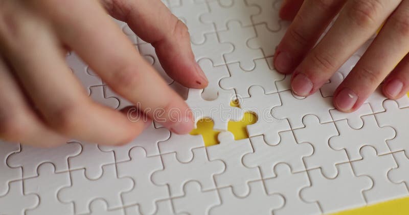 Female Hands Insert Missing Piece into White Puzzle on Table Stock ...