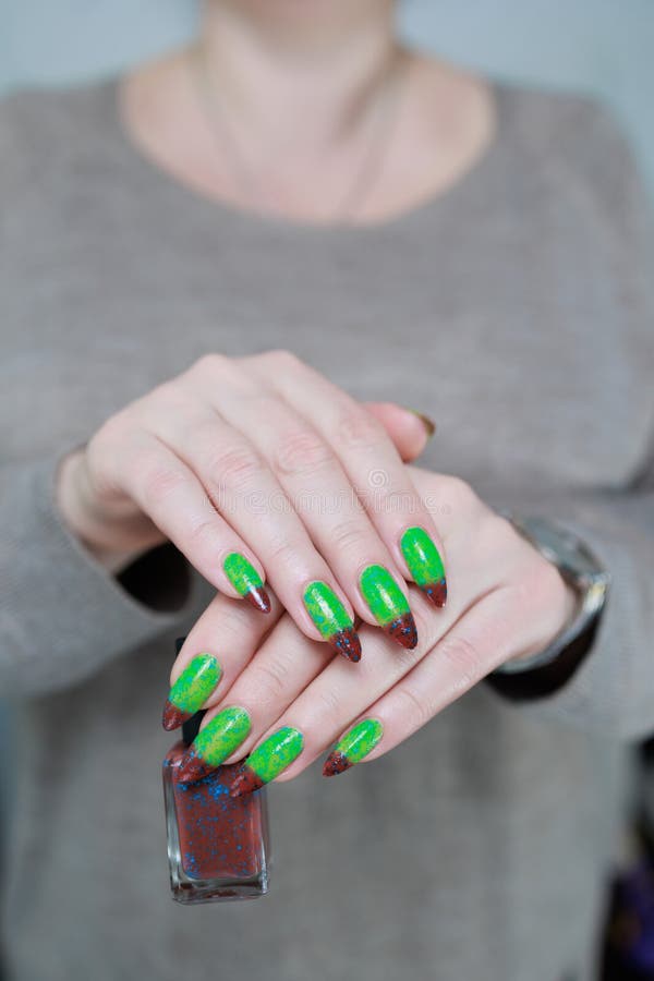 Female Hands with Long Nails and Green and Brown Manicure Stock Photo ...
