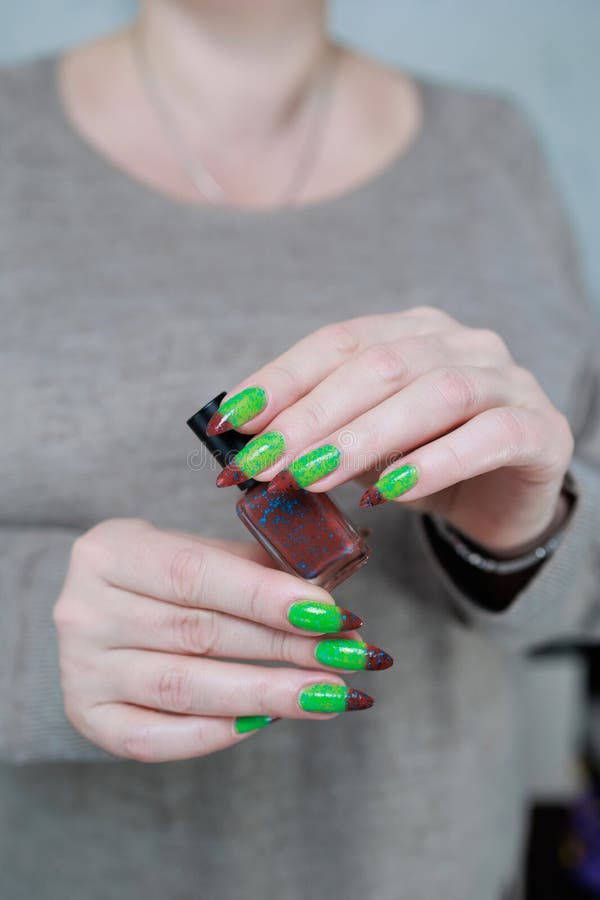Female Hands with Long Nails and Green and Brown Manicure Stock Image ...