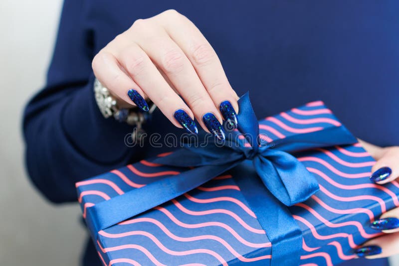 Female Hands with Long Nails Hold a Blue Gift Box Stock Image - Image ...