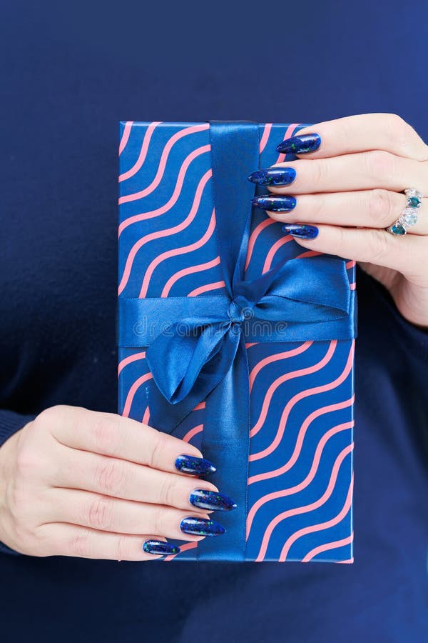Female Hands with Long Nails Hold a Blue Gift Box Stock Photo - Image ...