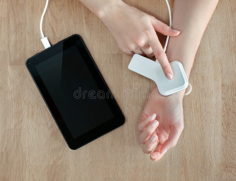Female Hands Measure the Pulse Using an Instrument Stock Image - Image ...