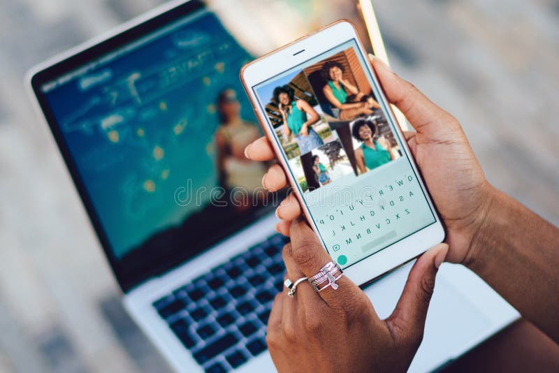 Female Hands with Mobile Phone Front Open Laptop Computer on Knees ...