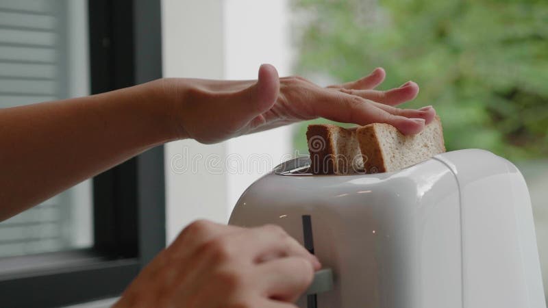 Female Hands Putting Bread into Toaster. Closeup Stock Footage - Video ...