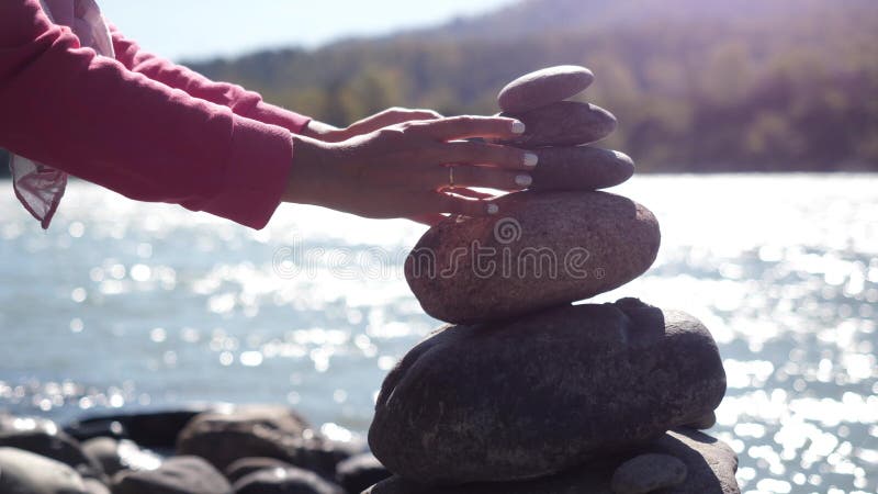 Female Hands Putting Pebble Stack Next To the Mountain River on Sunny ...
