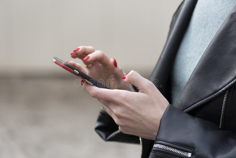 Female Hands with Red Manicure Holding Smartphone. Girl Using Mobile ...