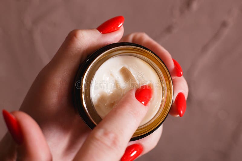 Female Hands with Red Nails Applied Hand Cream. Texture of Cream ...
