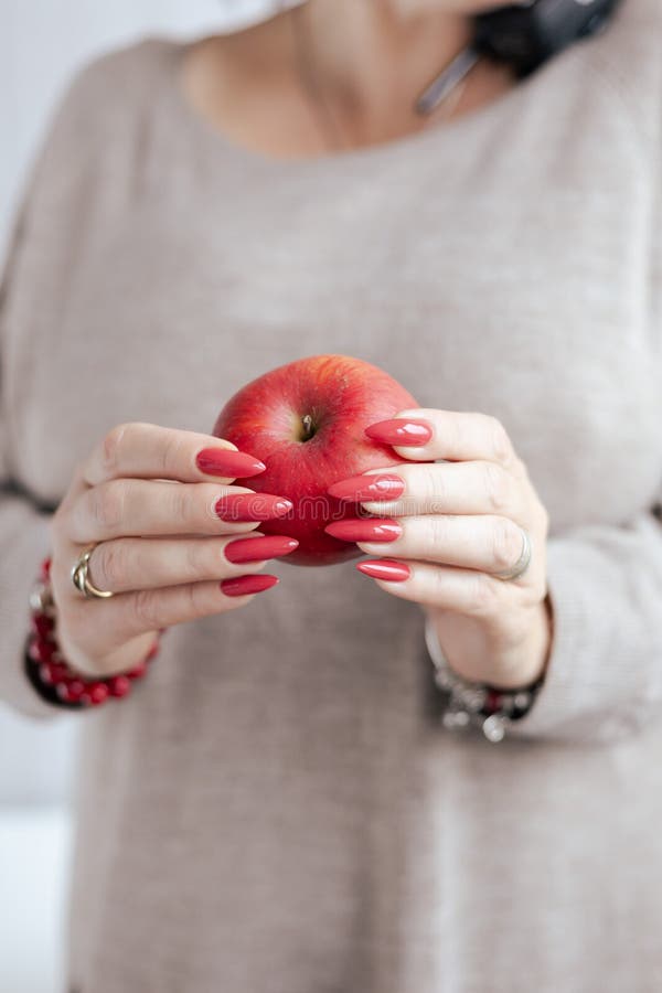 Female Hands with Red Nails are Holding a Ripe Red Apple Fruit. Stock ...