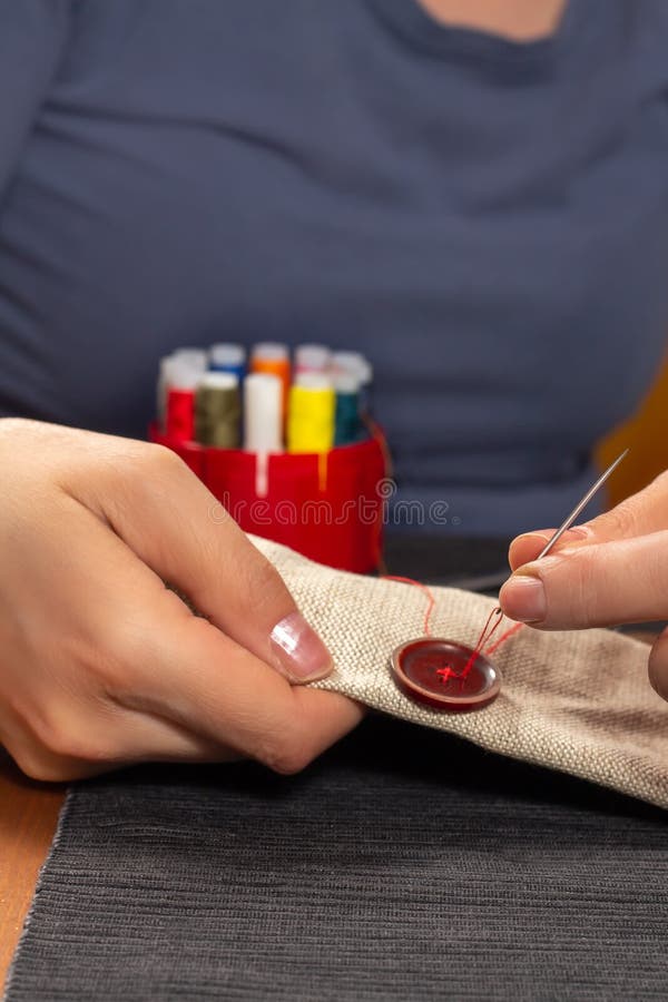 Repair of Clothes. Sewing on a Torn Button with a Needle and Thread ...