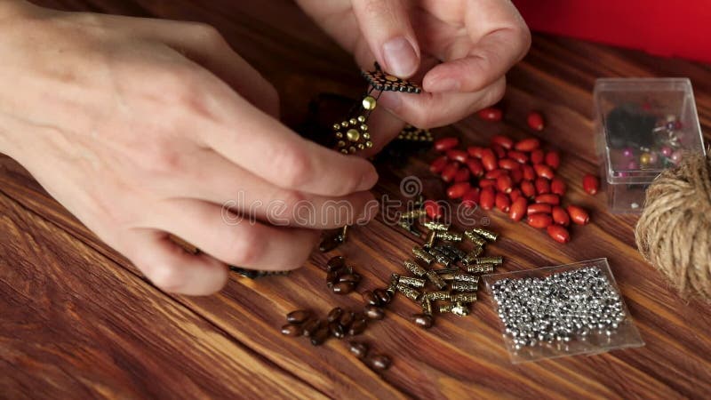 Female Hands Sorting through Multicolored Beads on Wooden Background ...