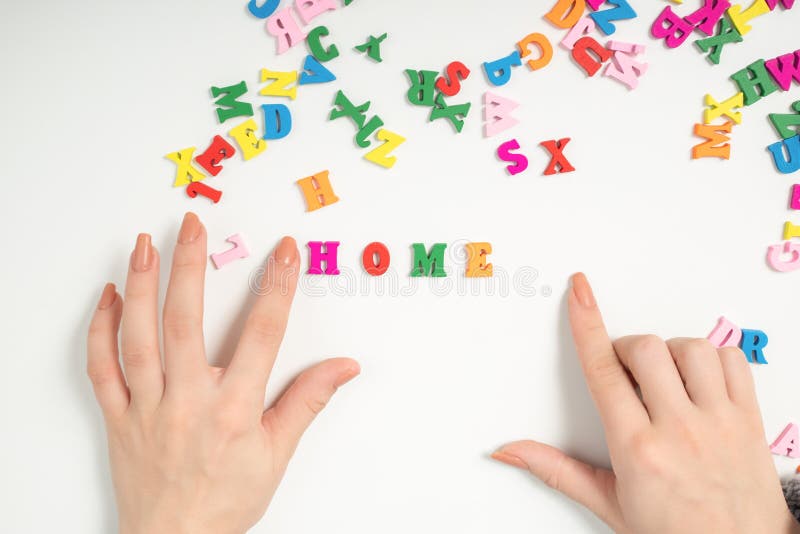 Female Hands Spread Out of Multi-colored Letters the Word Home Stock ...