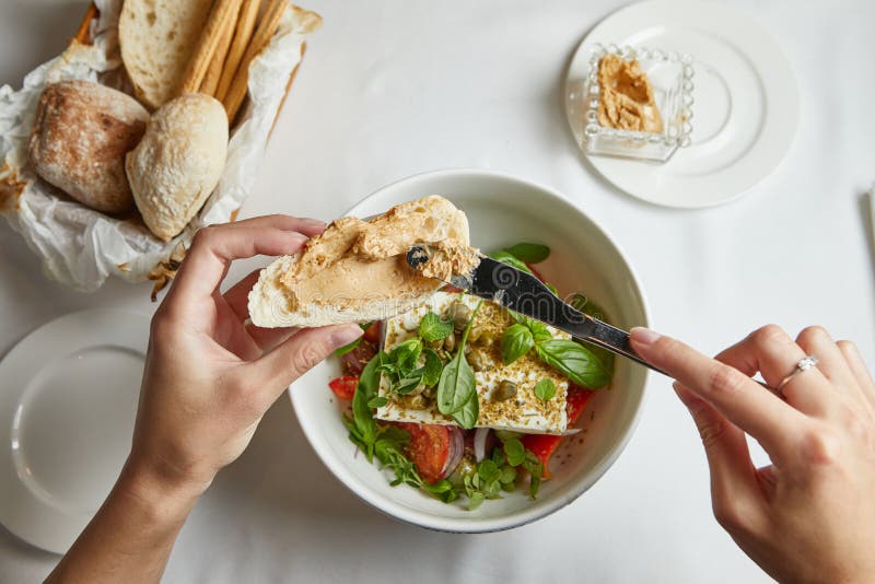 Female Hands while Spreading Butter on Bread while Eating Stock Photo ...