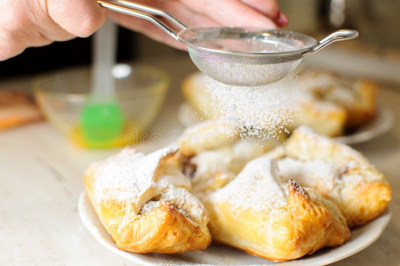 Female Hands Sprinkle Powdered Sugar on Apple Puffs Stock Photo - Image ...