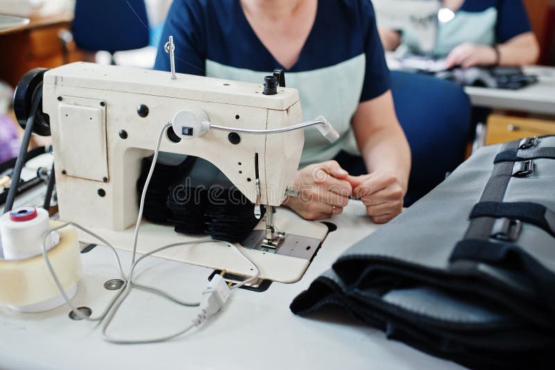 Female Hands Stitching Fabric on Professional Manufacturing Machine at ...