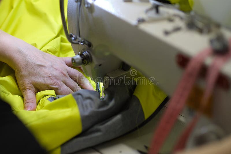 Female Hands Stitching White Fabric on Professional Manufacturing ...