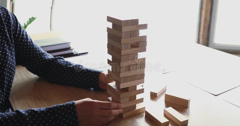 Female Hands Taking Bricks Out of Jenga Tower Falling Down Stock ...