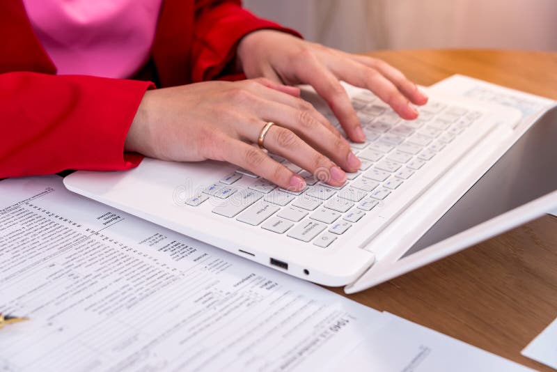 Female Hands Typing on Laptop with 1040 Form Stock Photo - Image of ...