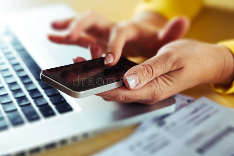 Female Hands Using Smart Phone while Working on Computer. Businesswoman ...