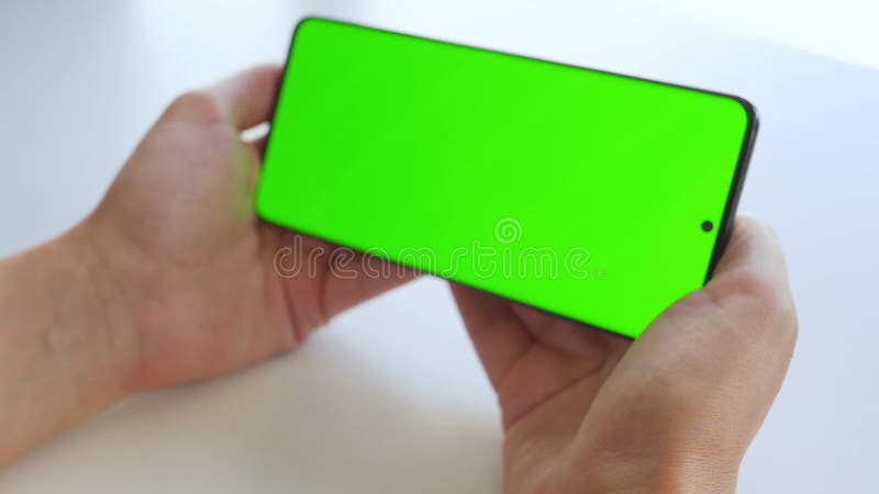 Female Hands Using a Smartphone with a Green Screen in Horizontal Mode ...