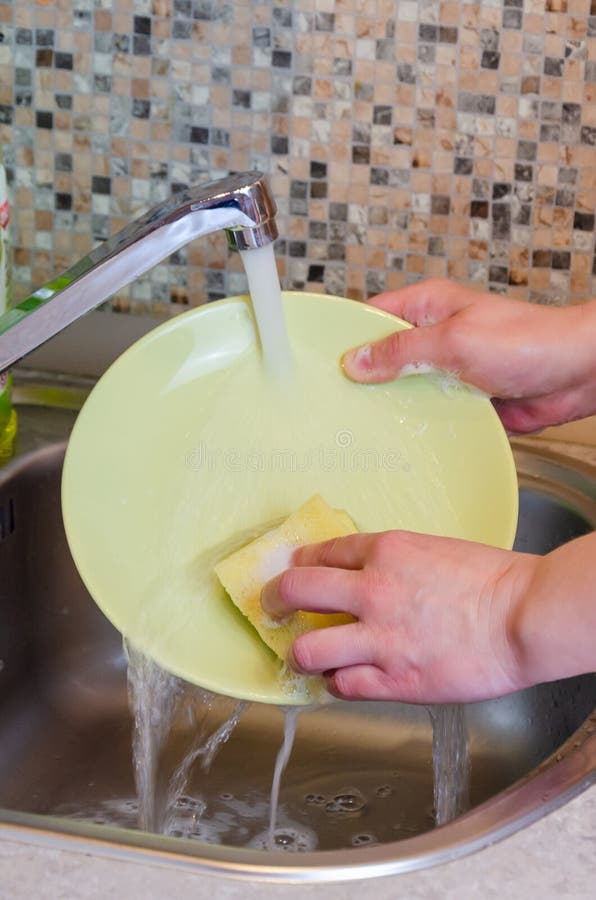 Female Hands Washing Plate in the Sink in the Kitchen with Sponge and ...