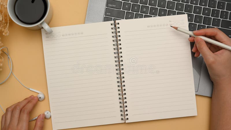 A Female Hands Writing Something on Spiral Notebook Pages Stock Image ...