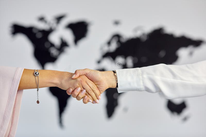 Female Handshake in Front of World Map on Stock Image - Image of ...
