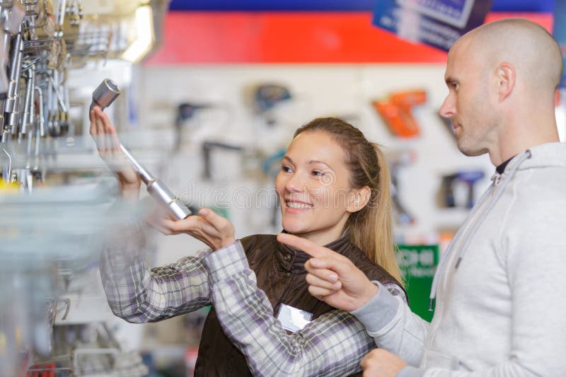 Female Hardwarer Store Worker Assisting Male Customer Stock Photo ...