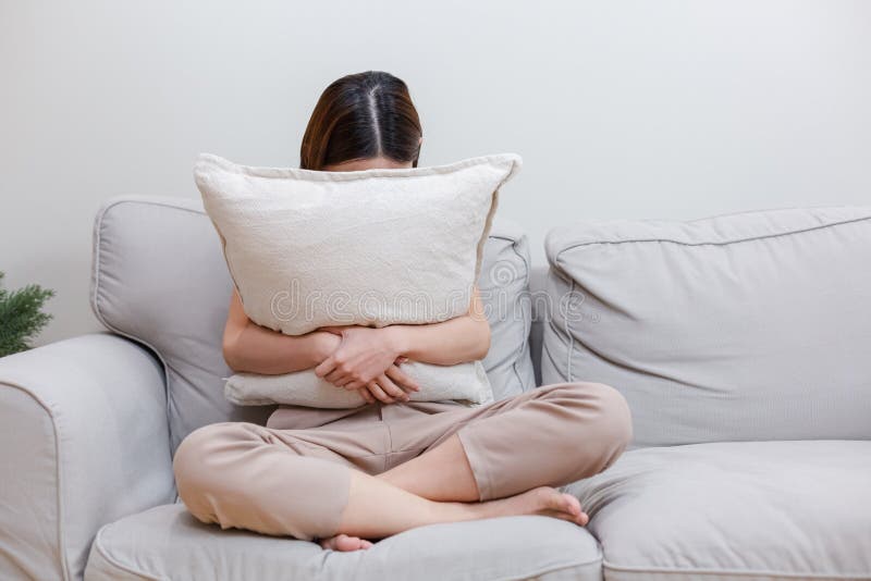 Female Having Depression Sitting Alone On Sofa She With Depressed