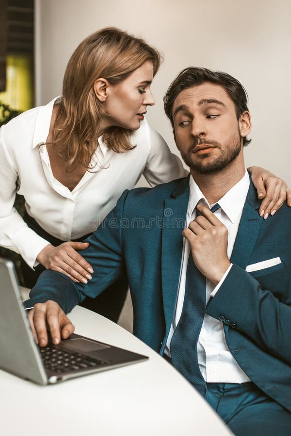 Love Affair At Work Business Man Kisses Neck Of A Woman Sitting On His