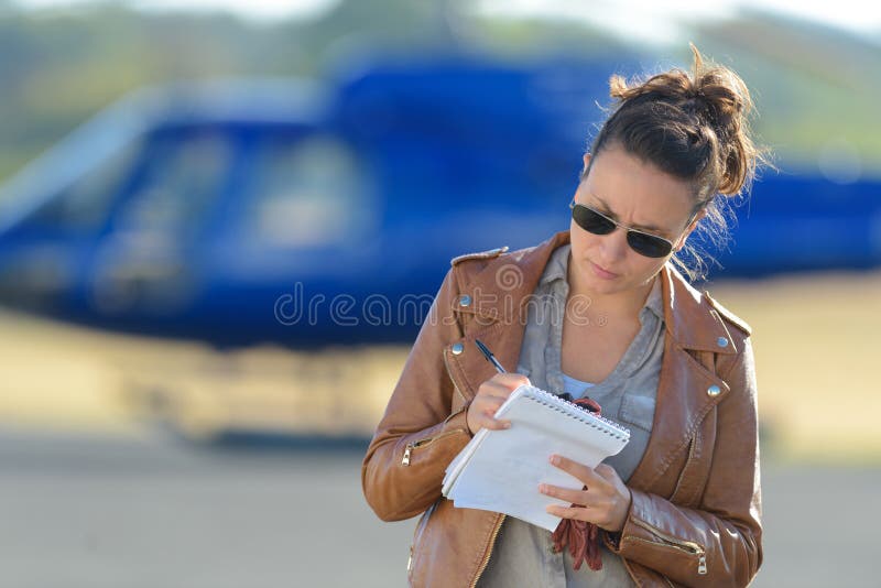 Female Helicopter Pilot Taking Note Stock Image - Image of people ...