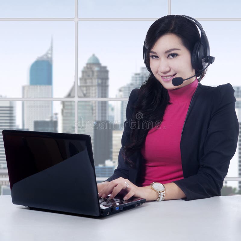 Female Helpline Operator with Laptop Stock Photo - Image of microphone ...