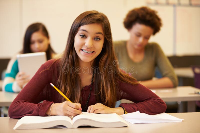 Female High School Student Studying at Desk in Classroom Stock Photo ...