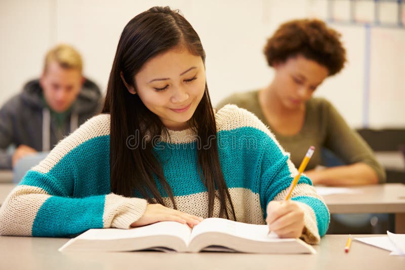 Female High School Student Studying at Desk in Classroom Stock Photo ...