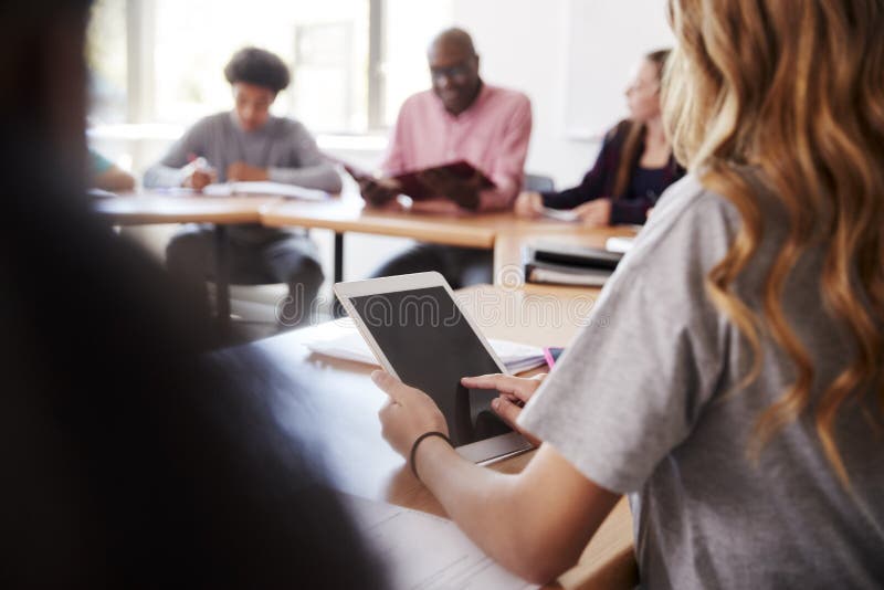Female High School Student Using Digital Tablet Whilst Sitting at Desk ...