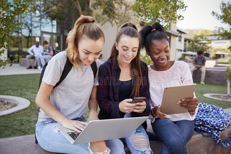 High School Teacher Talking To Pupils Using Digital Devices in ...