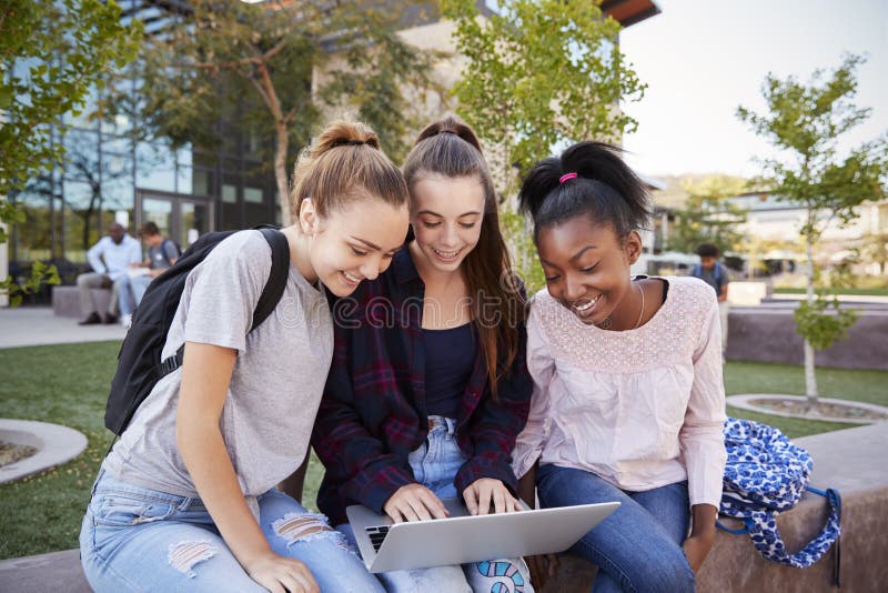 Female High School Students Using Digital Devices Outdoors during ...