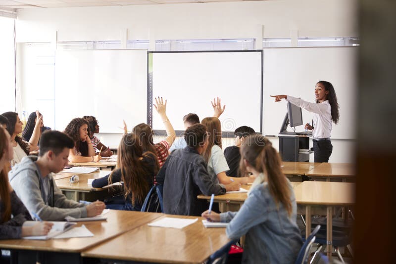 Female High School Teacher Standing in Front of Interactive Whiteboard ...