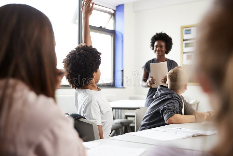 Female High School Tutor Standing by Table with Students Teaching ...