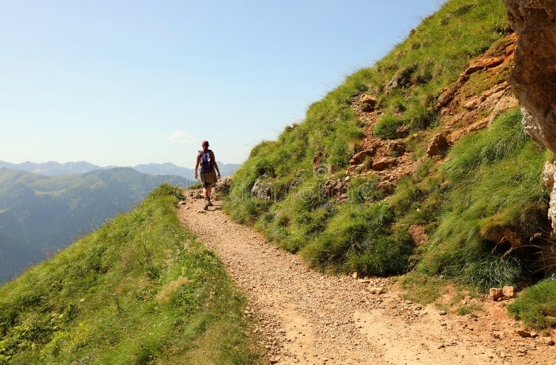 Female Hiker with Backpack Walking on Dirt Trail in Mountains Stock ...