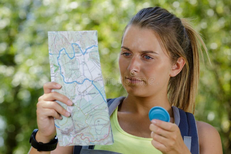 Female Hiker Checking Map while Holding Compass Stock Photo - Image of ...