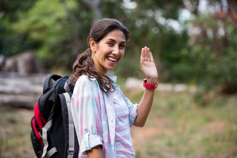 Female Hiker Waving Hand while Walking in Forest Stock Photo - Image of ...