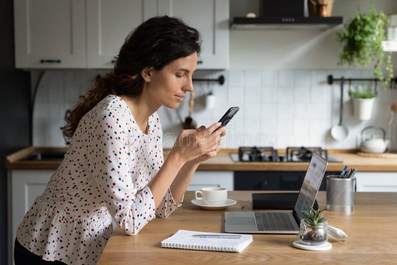 Female Hispanic Remote Employee Working at Laptop from Home Stock Photo ...