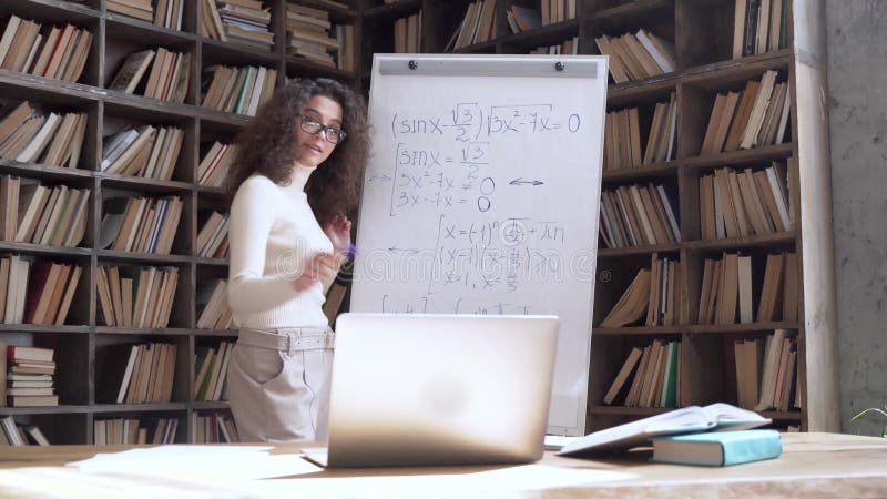 Female Hispanic Teacher Explaining Math Giving Remote Online Math Class ...