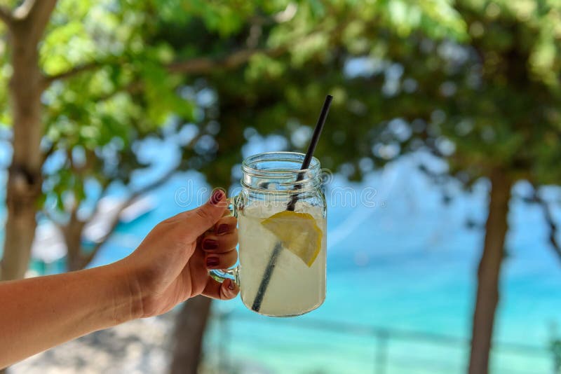 Female Holding a Jar of Fresh Lemonade at the Beach Stock Image - Image ...