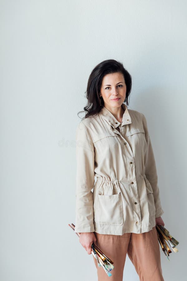 Female Artist Holding Paint Brushes in Her Hands Stock Image - Image of ...