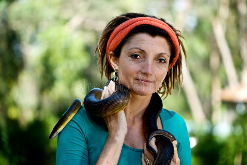 Female Holding Snake with Blurred Green Background Stock Photo - Image ...