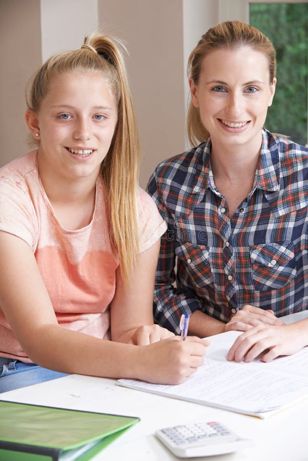 Female Home Tutor Helping Girl with Studies Using Digital Tablet Stock ...