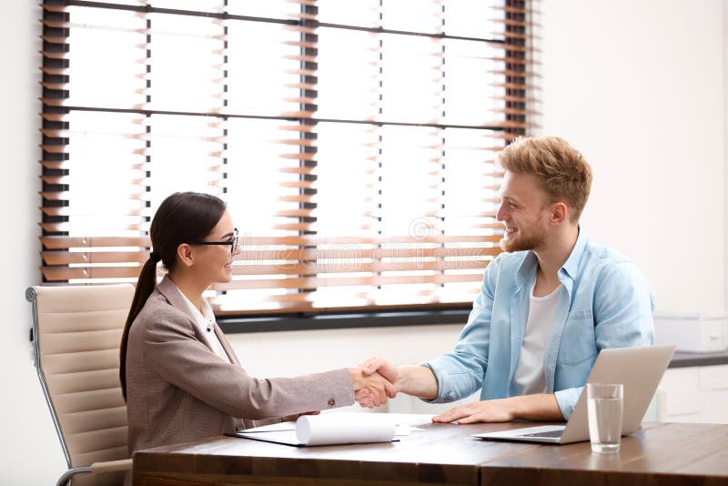 Female Insurance Agent Shaking Hands with Client Stock Photo - Image of ...