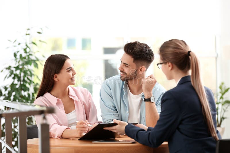 Female Insurance Agent Working with Couple in Office Stock Image ...