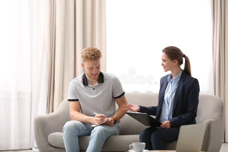 Female Insurance Agent Working with Young Man Stock Photo - Image of ...
